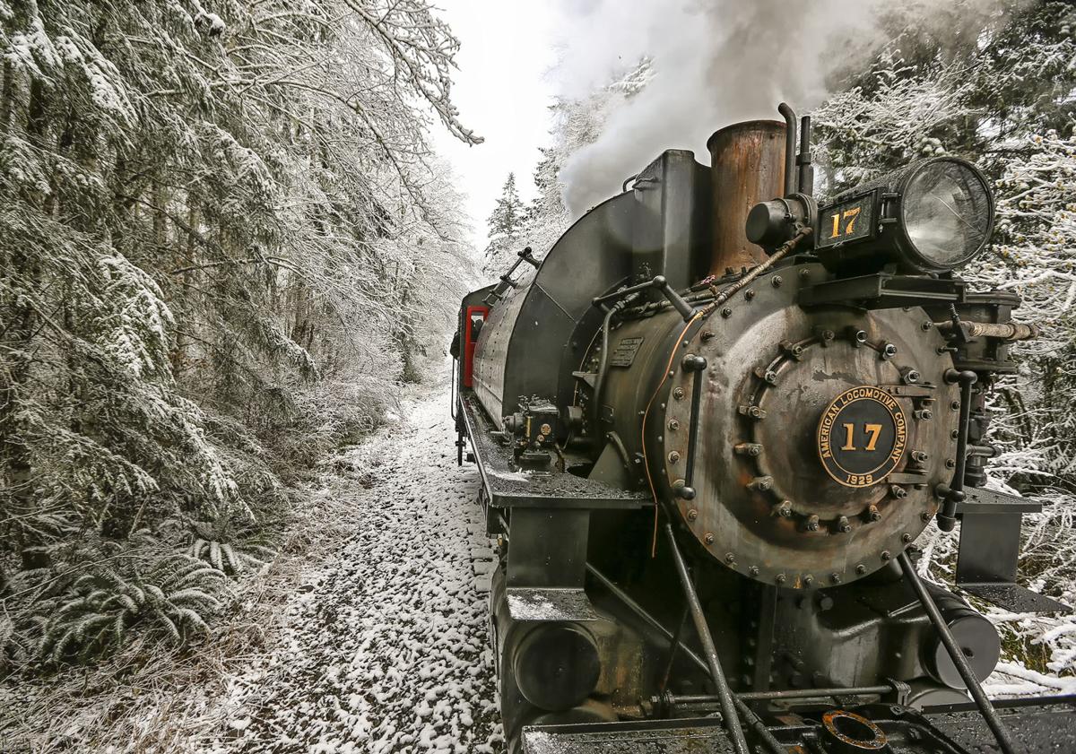 Mount Rainier Scenic Railroad stamps visitors’ boarding passes with the ...