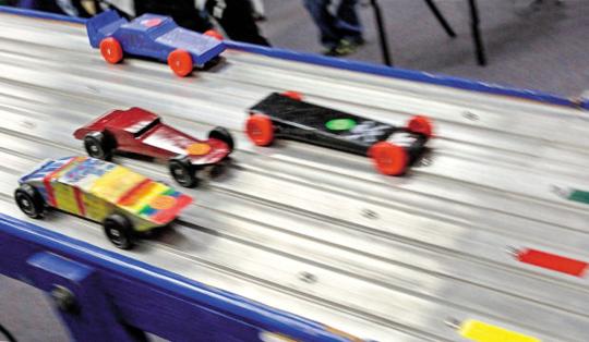 Cub Scouts race mini cars at Pinewood Derby