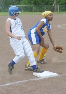 Michaela Bennett comes safely to the base as Johnson's third baseman ...