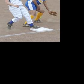 Michaela Bennett comes safely to the base as Johnson's third baseman ...