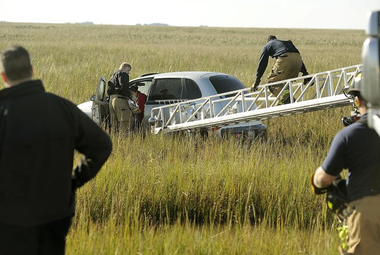 Firefighters pluck driver from marsh with ladder truck | Local News ...