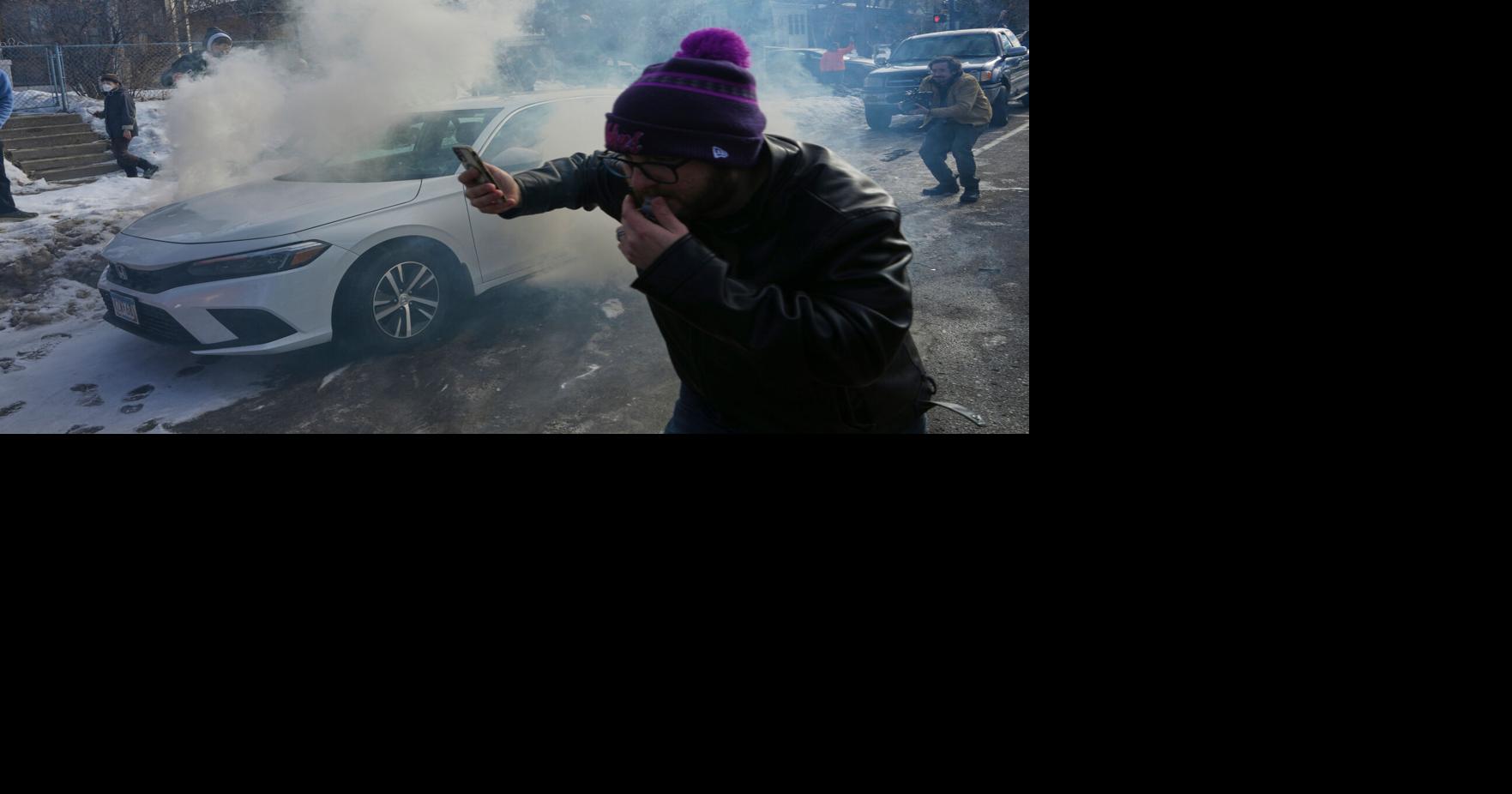 Crowd yells 'cowards!' after federal agents crash into a car and fire ...