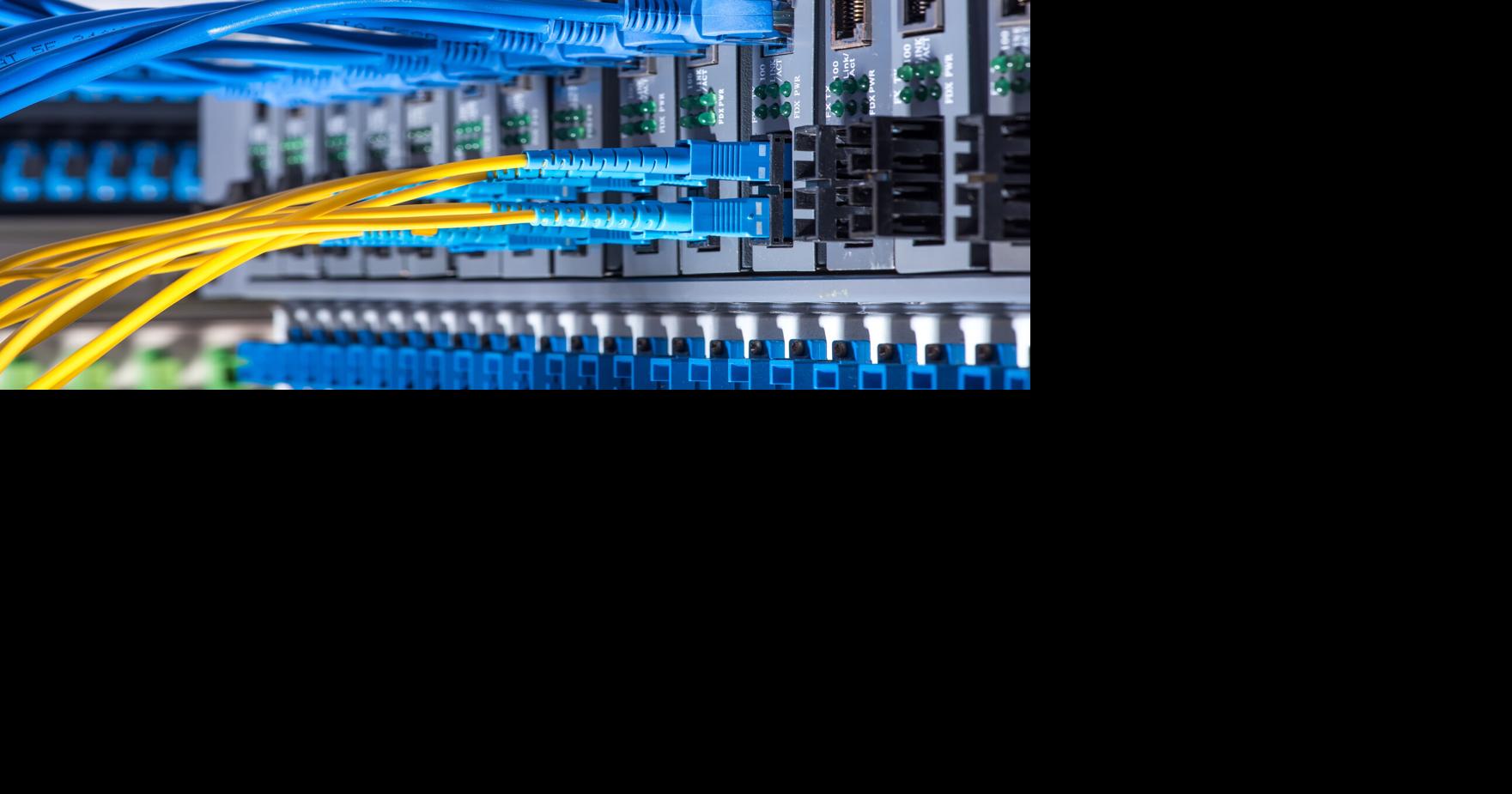 AdobeStock_100999003 Fiber Optic cables connected to optic ports and ...