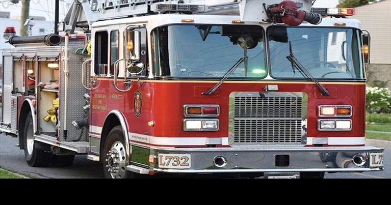Halton Hills firefighters battling house fire with smoke showing on arrival