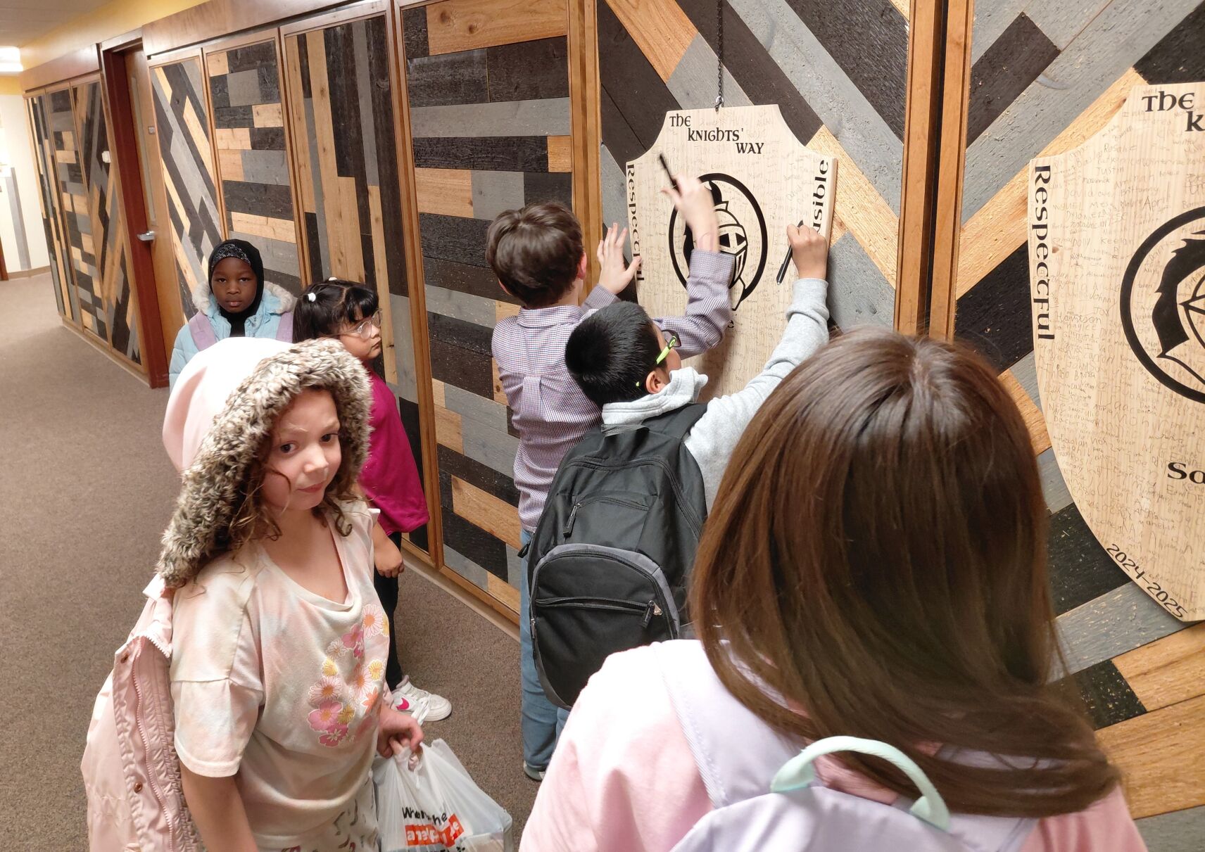 Grand Island elementary students sign Knight's shield