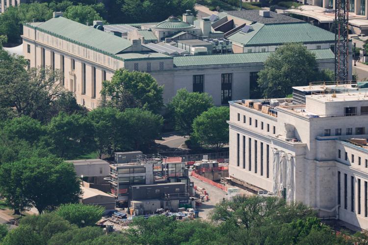 Fed holds rates steady, citing elevated inflation