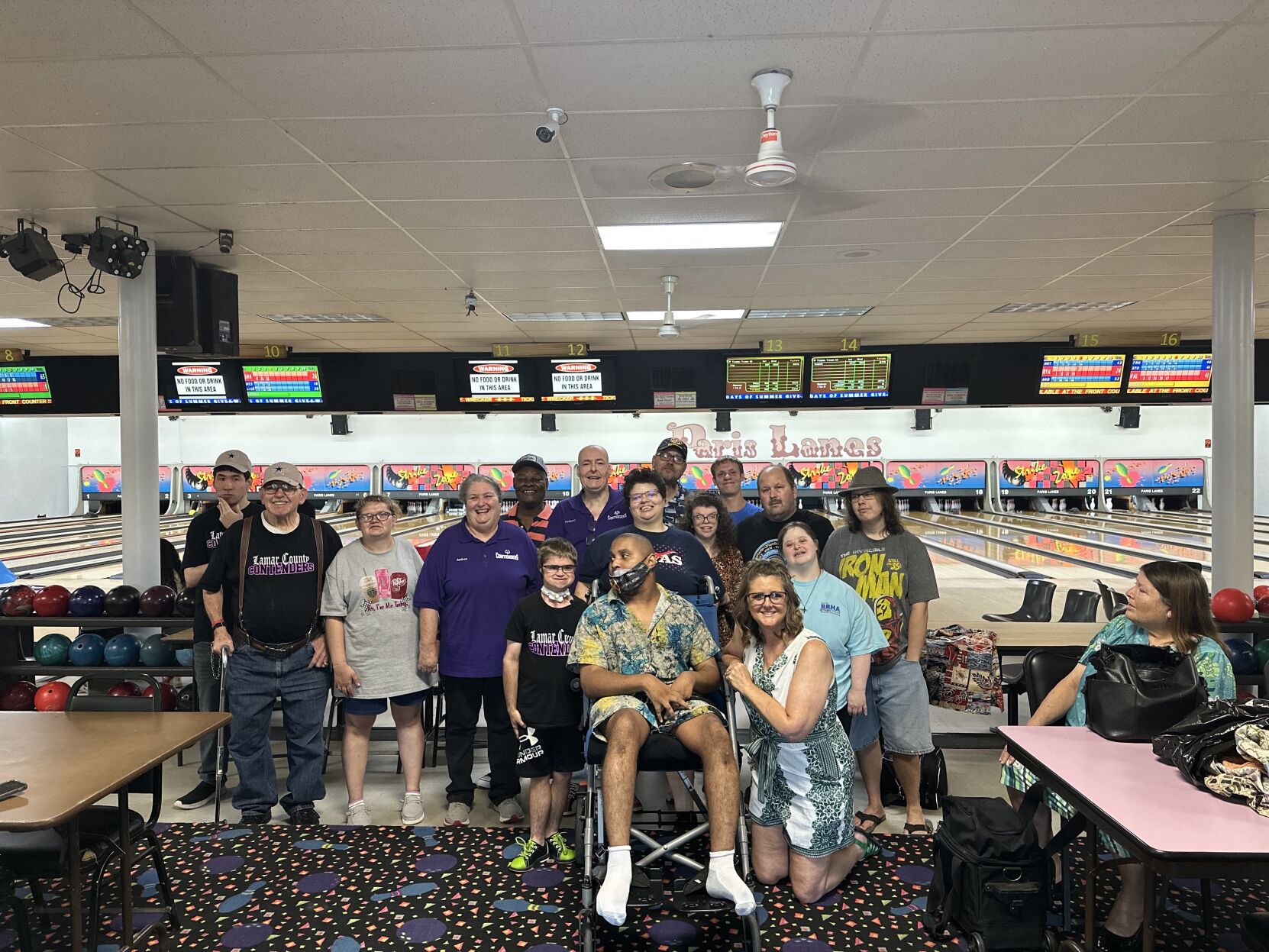 group, man in wheelchair in center.jpeg | | theparisnews.com