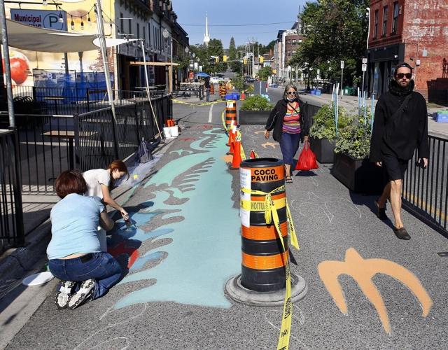 Photos: Road murals being painted on Hunter Street in downtown Peterborough