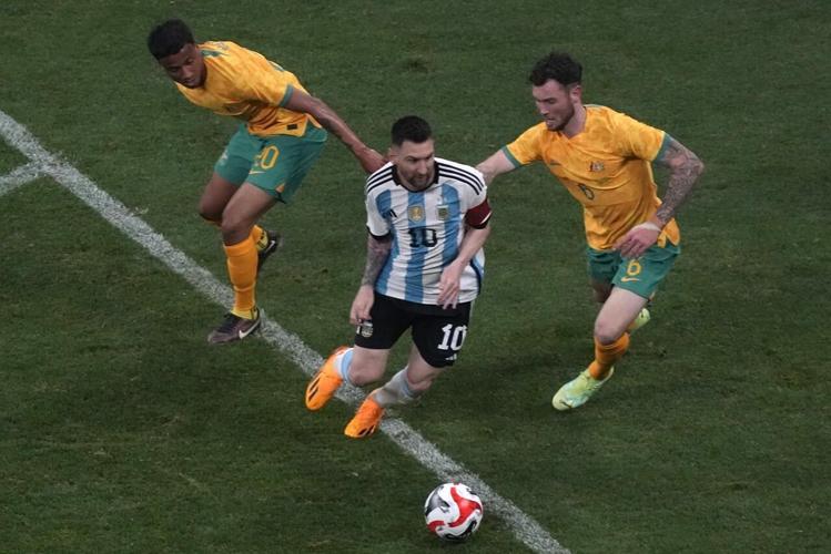 Lionel Messi scores, gets hugged by a fan during Argentina’s 2-0 win ...