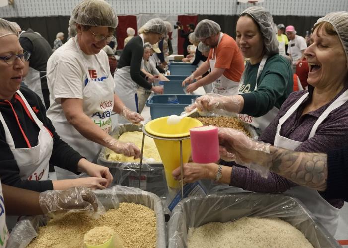 Team of volunteers pack meals for the hungry