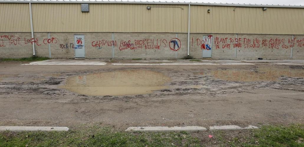 Nicholls Oval gate, Morrow Building covered with graffiti in separate ...