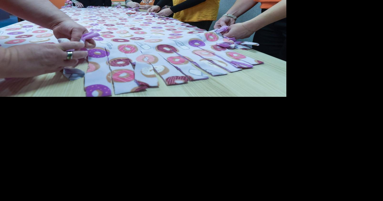 Volunteers craft blankets for Kids at Christmas campaign