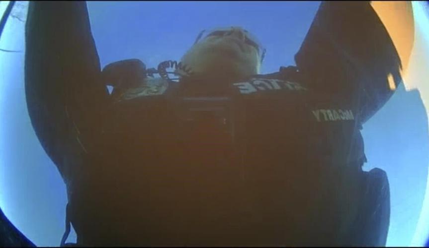 Video shows driver fleeing Iowa police with officer on hood, roof of car