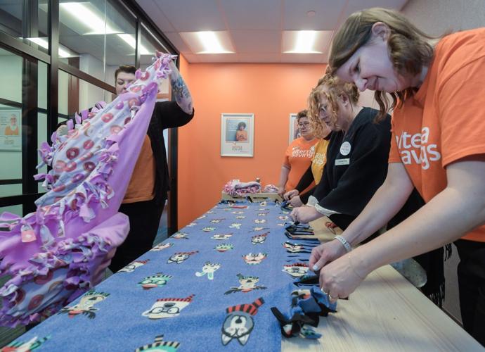 Volunteers craft blankets for Kids at Christmas campaign