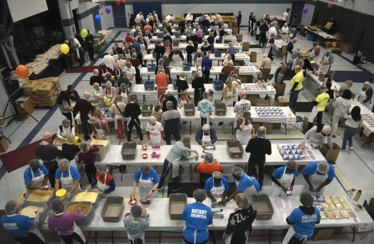 Team of volunteers pack meals for the hungry