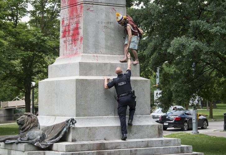Man climbs vandalized Queen Victoria statue in Kitchener park for five ...