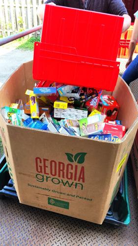 Volunteer group promoting Cambridge Food Bank summer drives