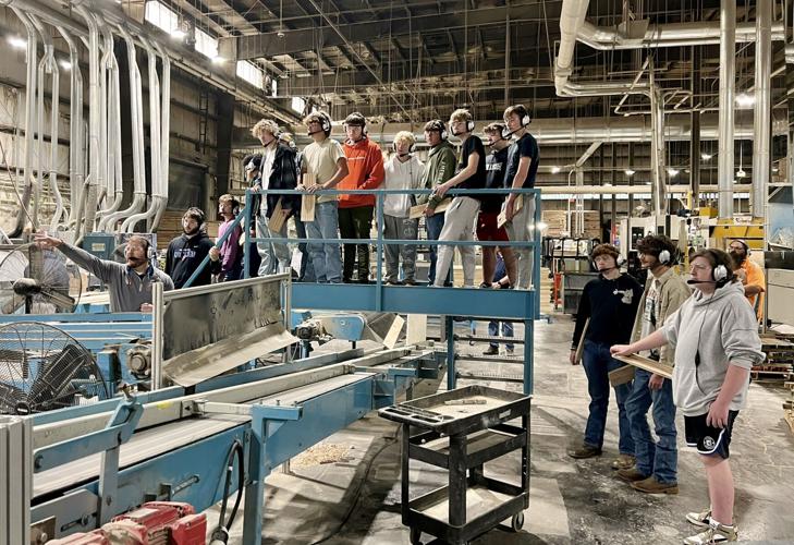 Volunteer students learn about manufacturing during Mullican Flooring ...