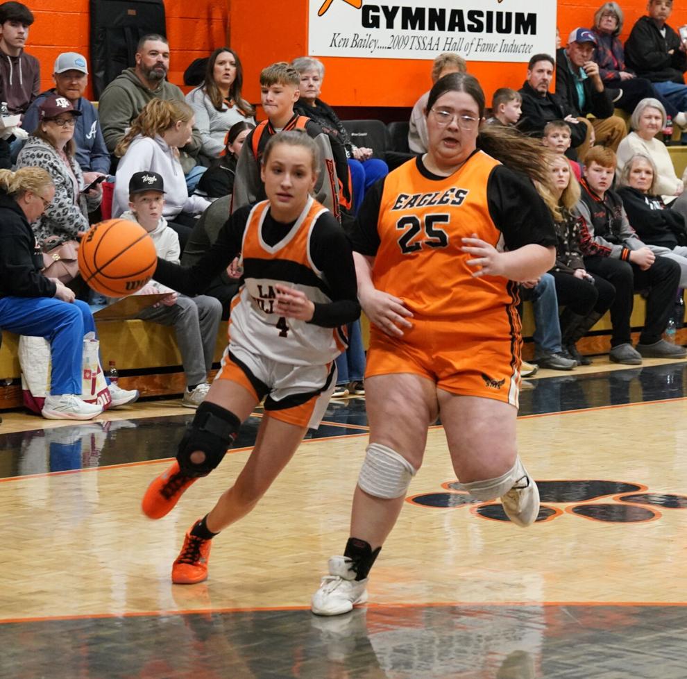 01) Kinsley Price drives past Shelby Livesay. | | therogersvillereview.com