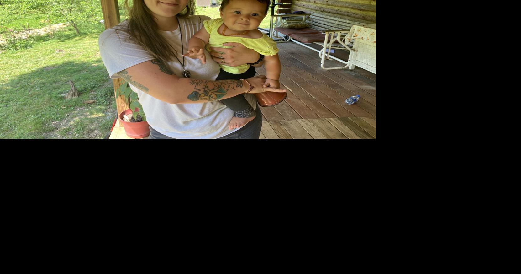 Emily Walker and baby Elaina Gonzalez wait on the porch while Ivan ...