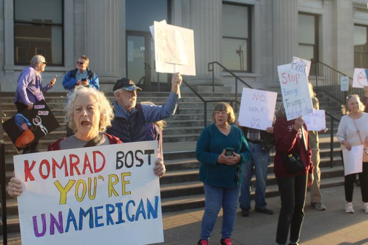 Bost hosts rescheduled telephone town hall; dozens protest in ...