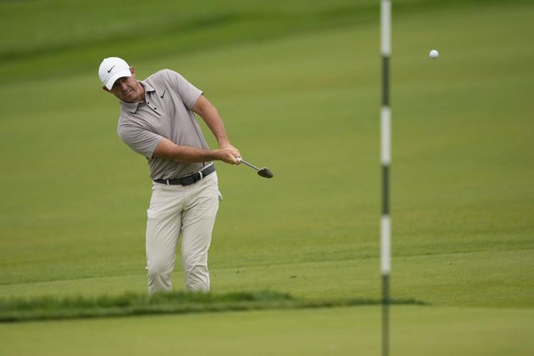 A caddie at heart, Bones Mackay makes sure to get the 18th flag to Spaun's bagman