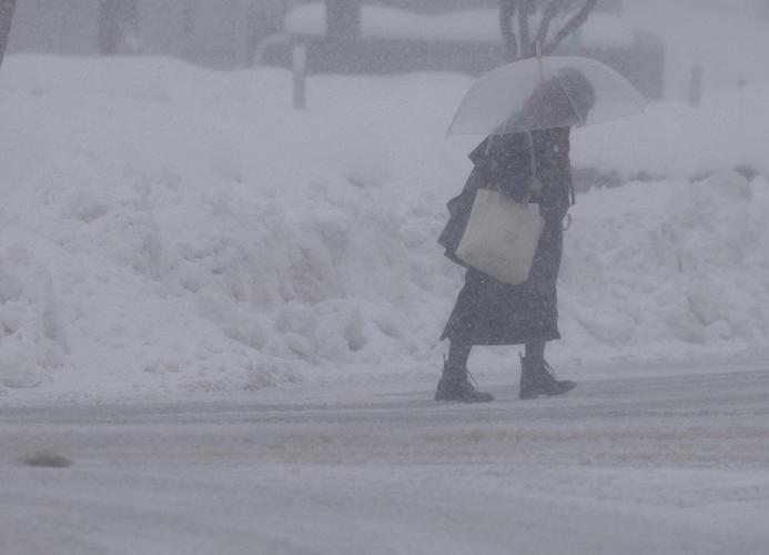 Heavy snow in northern Japan blocks roads and causes dozens of deaths