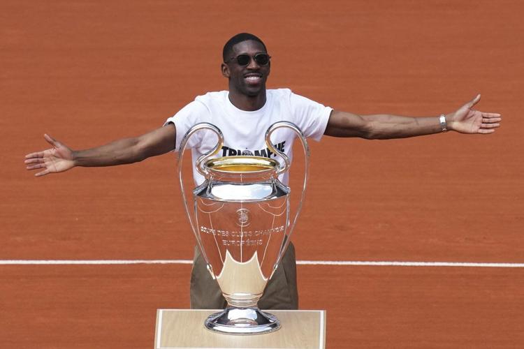 PSG star Dembélé raises Champions League trophy at the French Open