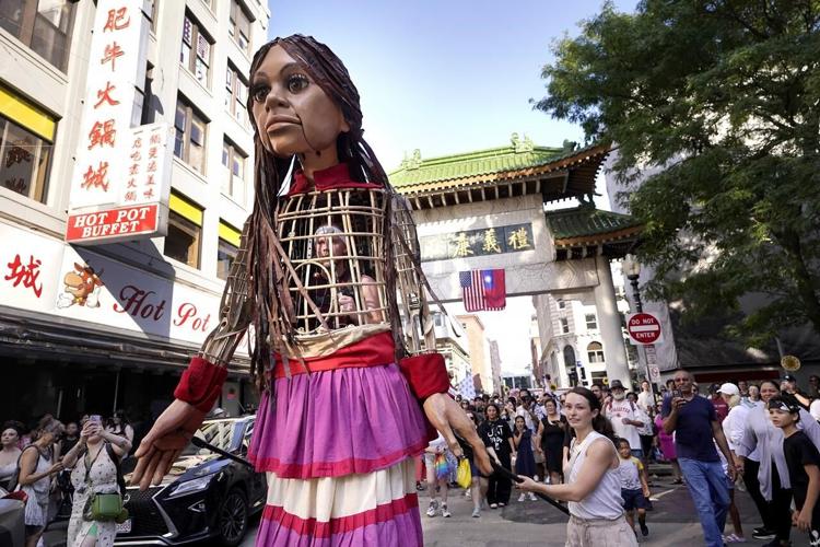 Little Amal, a 12-foot puppet of a Syrian refugee, began its journey ...