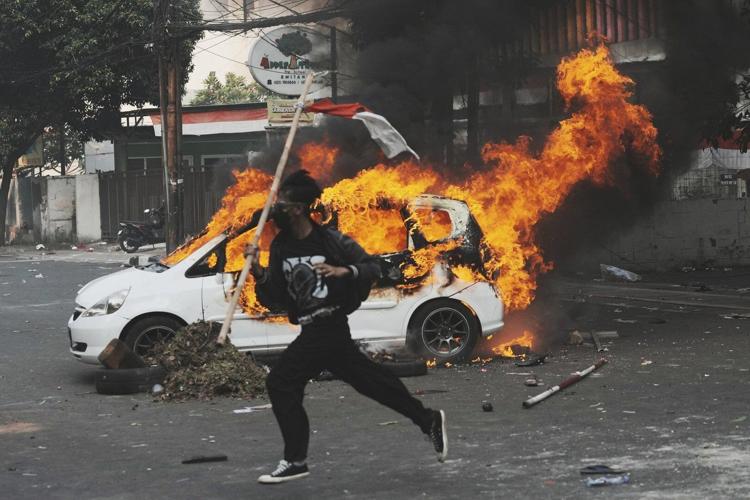 Photos of violent clashes between riot police and protesters in Indonesia