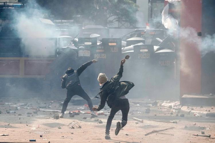 Photos of violent clashes between riot police and protesters in Indonesia