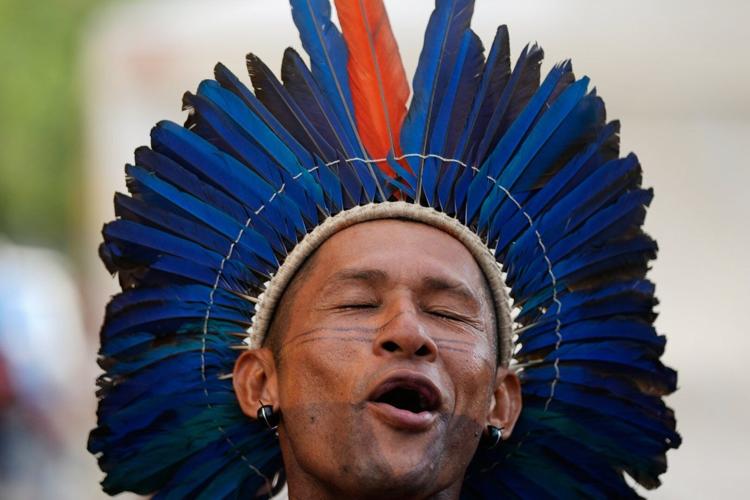 Photos show Indigenous participants at the People's Summit held ...