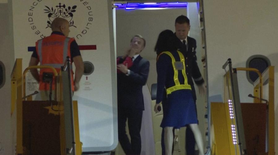 France's first lady seems to push her husband as they land in Vietnam ...