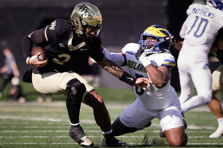 Ashford throws for three TDs as Wake Forest whips Delaware 52-14
