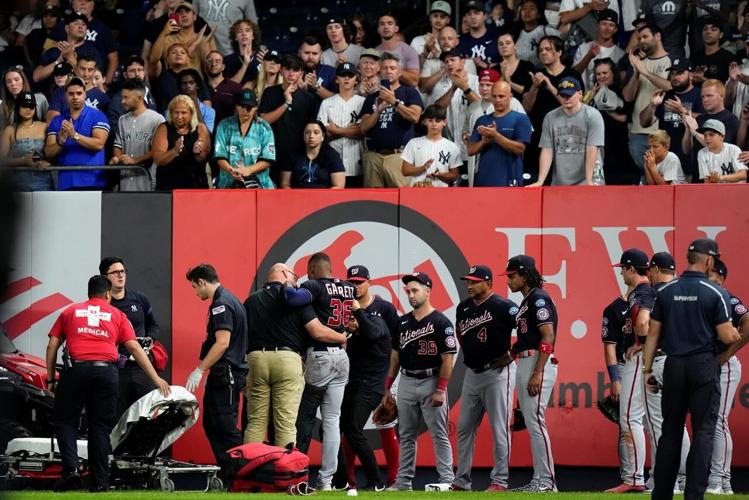 Nationals' Stone Garrett broke his left leg trying to rob a home run at Yankee Stadium