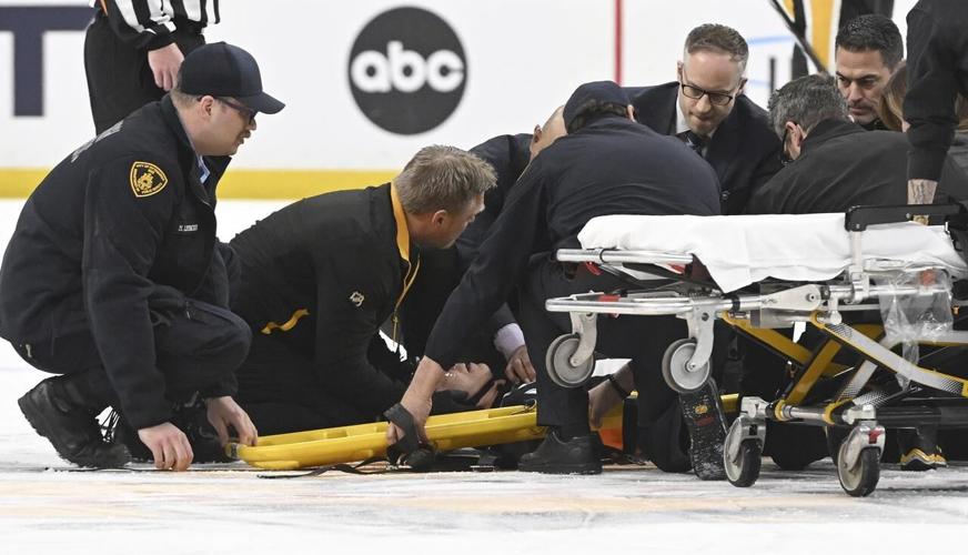 Referee Steve Kozari taken off ice on stretcher after collision with ...