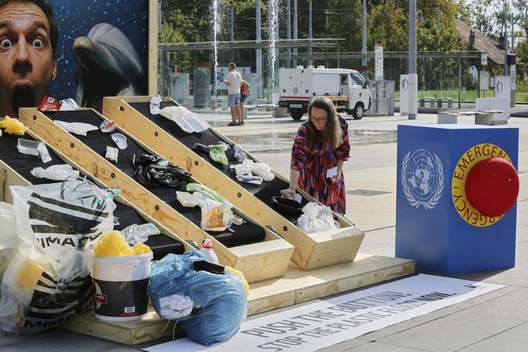 Campaigners of a sweeping plastics treaty climb buildings, hand out ...