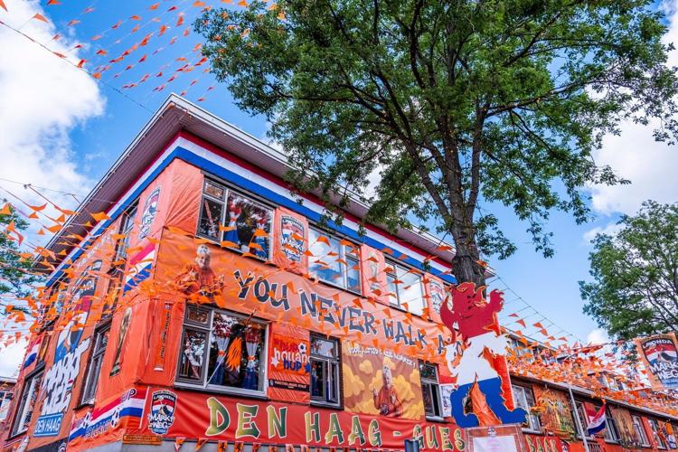 A street in The Hague is drenched in orange as Netherlands soccer fans ...