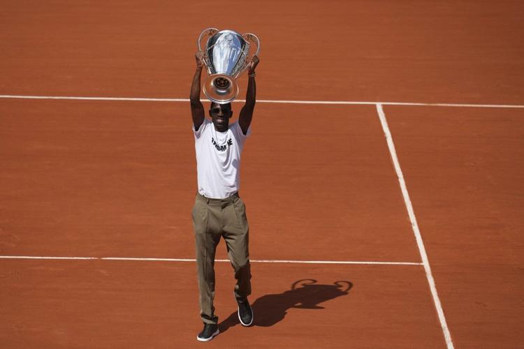 PSG star Dembélé raises Champions League trophy at the French Open