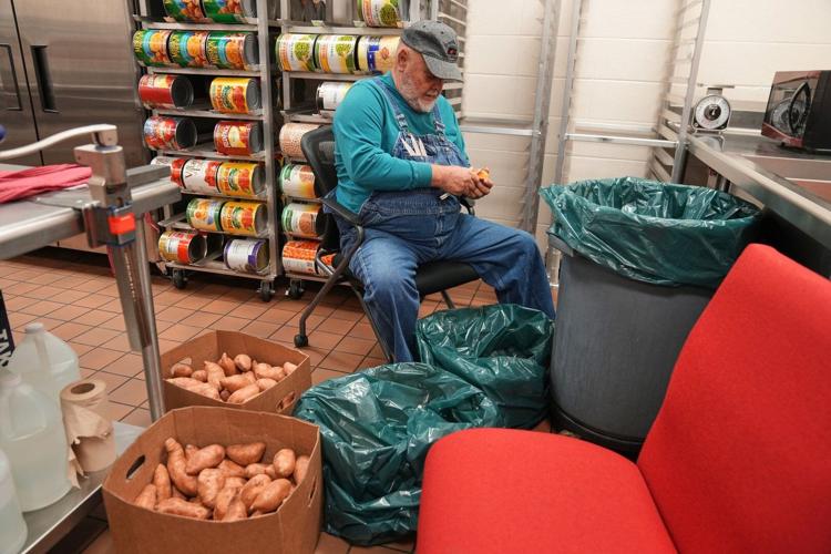 A cafeteria worker prepares a Thanksgiving meal to feed hundreds