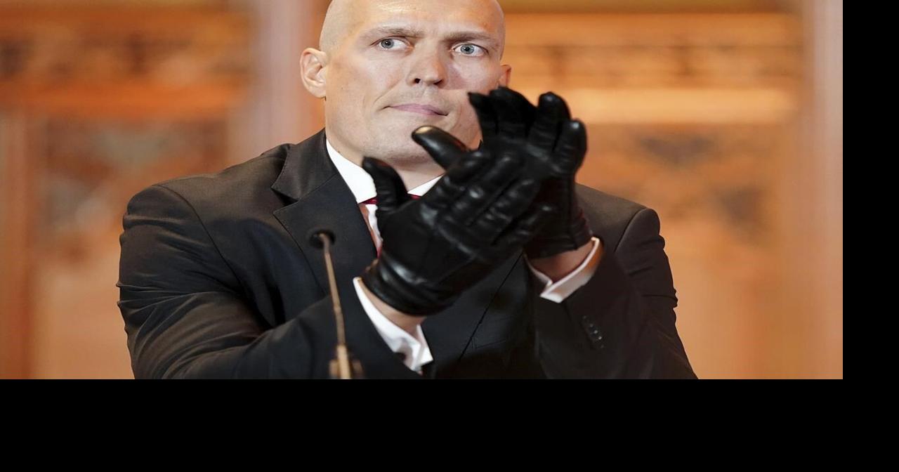 Usyk dresses as a hitman and gets Fury's signature in bizarre news ...