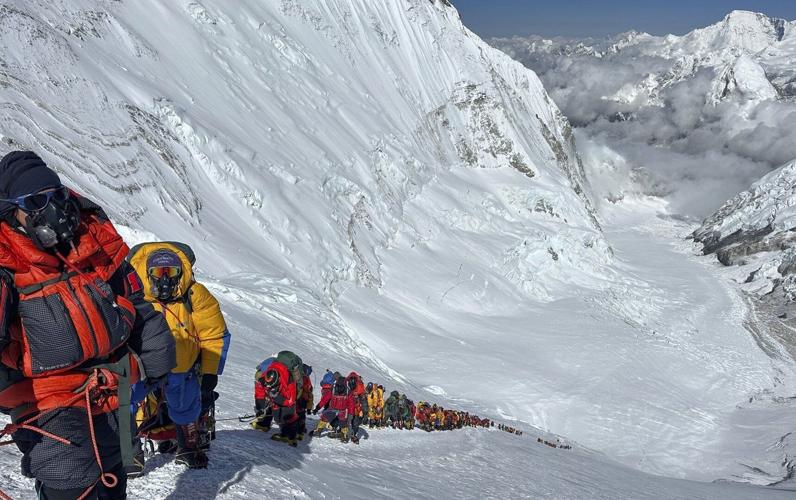 AP PHOTOS: Hundreds scale Mount Everest in a weather-hit climbing season