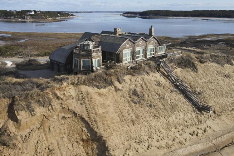 Wind and water are slowly taking this luxury house overlooking Cape Cod Bay