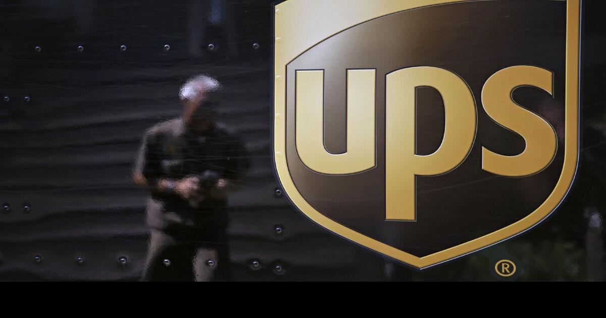 UPS profit slides, offers tepid 2015 outlook