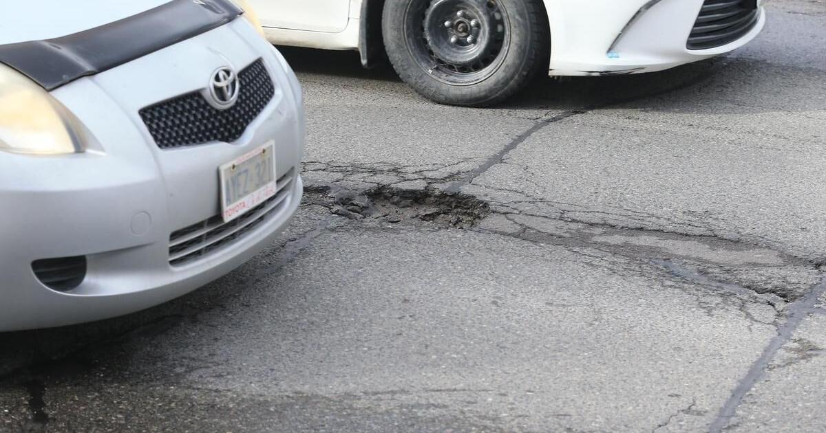 How do I file a claim for pothole damage with the city?