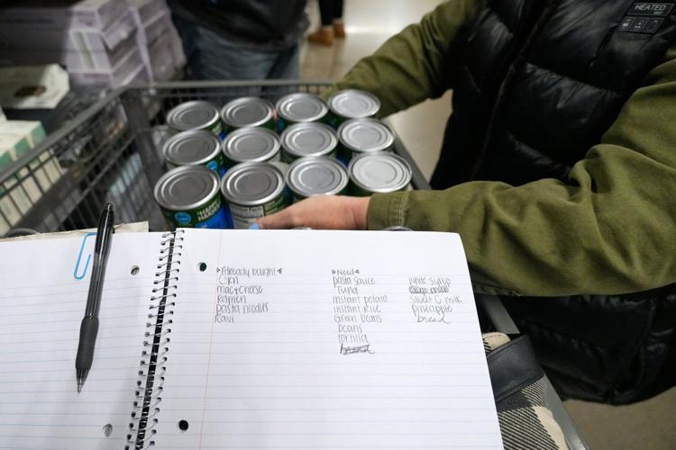 A cafeteria worker prepares a Thanksgiving meal to feed hundreds