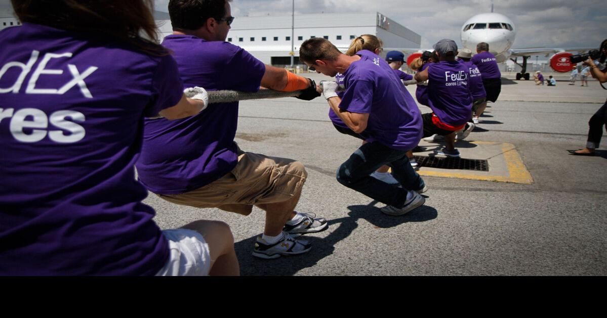 Plane-pulling teams flex muscles for charity