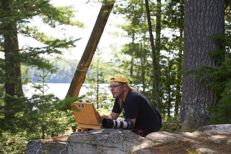 On Canoe Lake, painting a stroke behind Tom Thomson