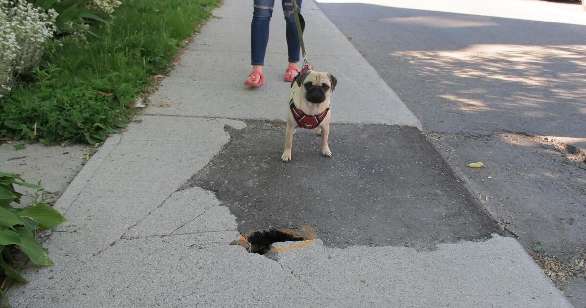 This sinking patch has created a sidewalk hole that could swallow a ...