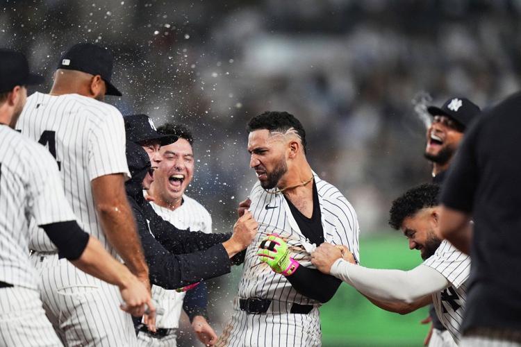Yankees rally past White Sox 3-2, clinch playoff berth and close within 1 game of Toronto in AL East